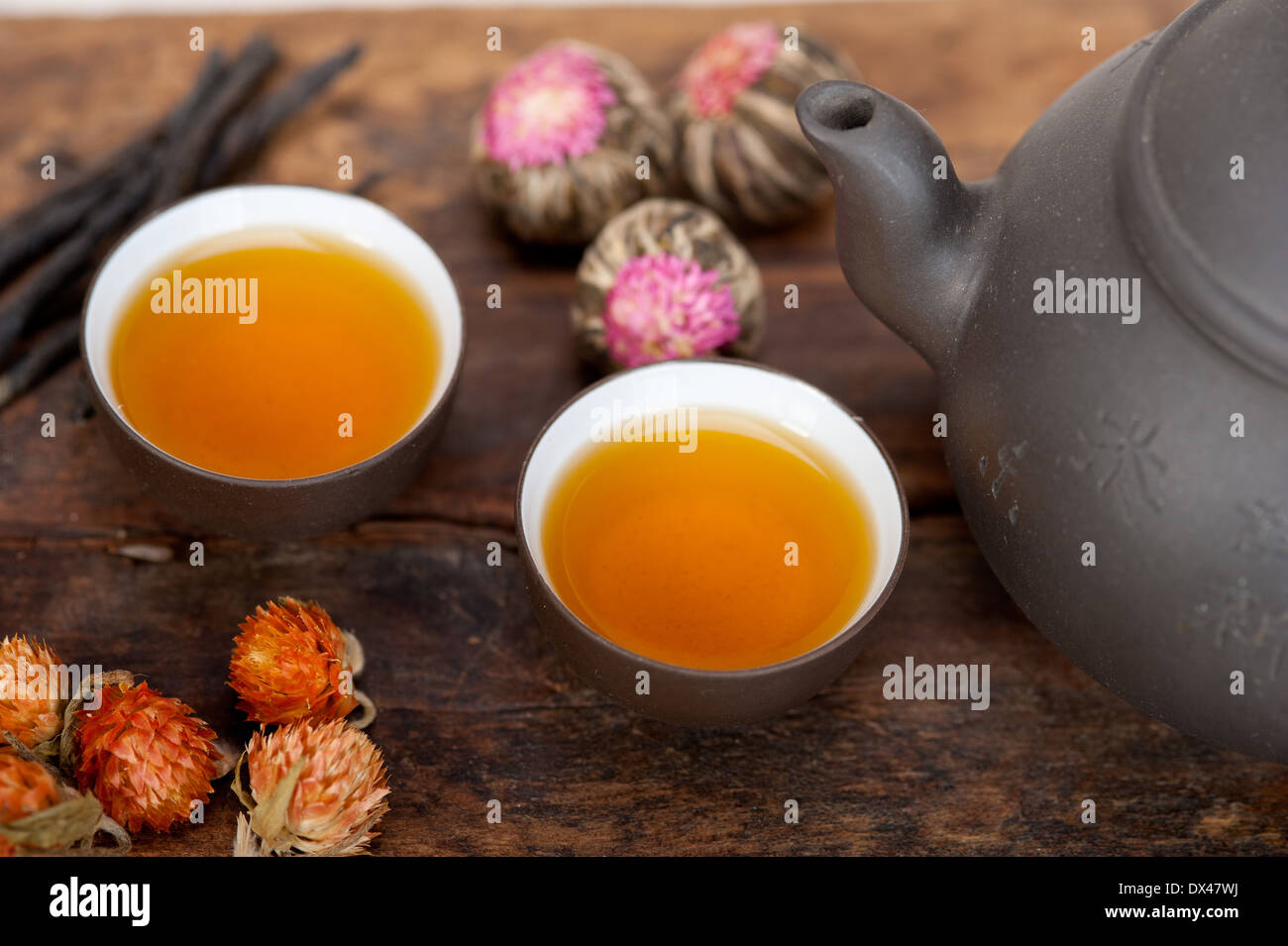 Chinese style herbal floral tea over wood table with raw ingredients ...