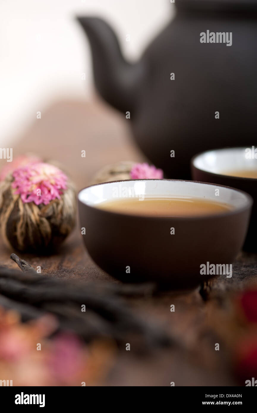 Chinese style herbal floral tea over wood table with raw ingredients ...