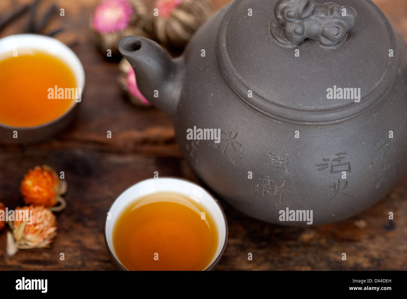 Chinese style herbal floral tea over wood table with raw ingredients ...