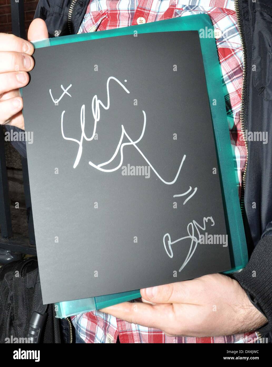 Bono fan Gary Paul shows his signed card after meeting him outside The ...
