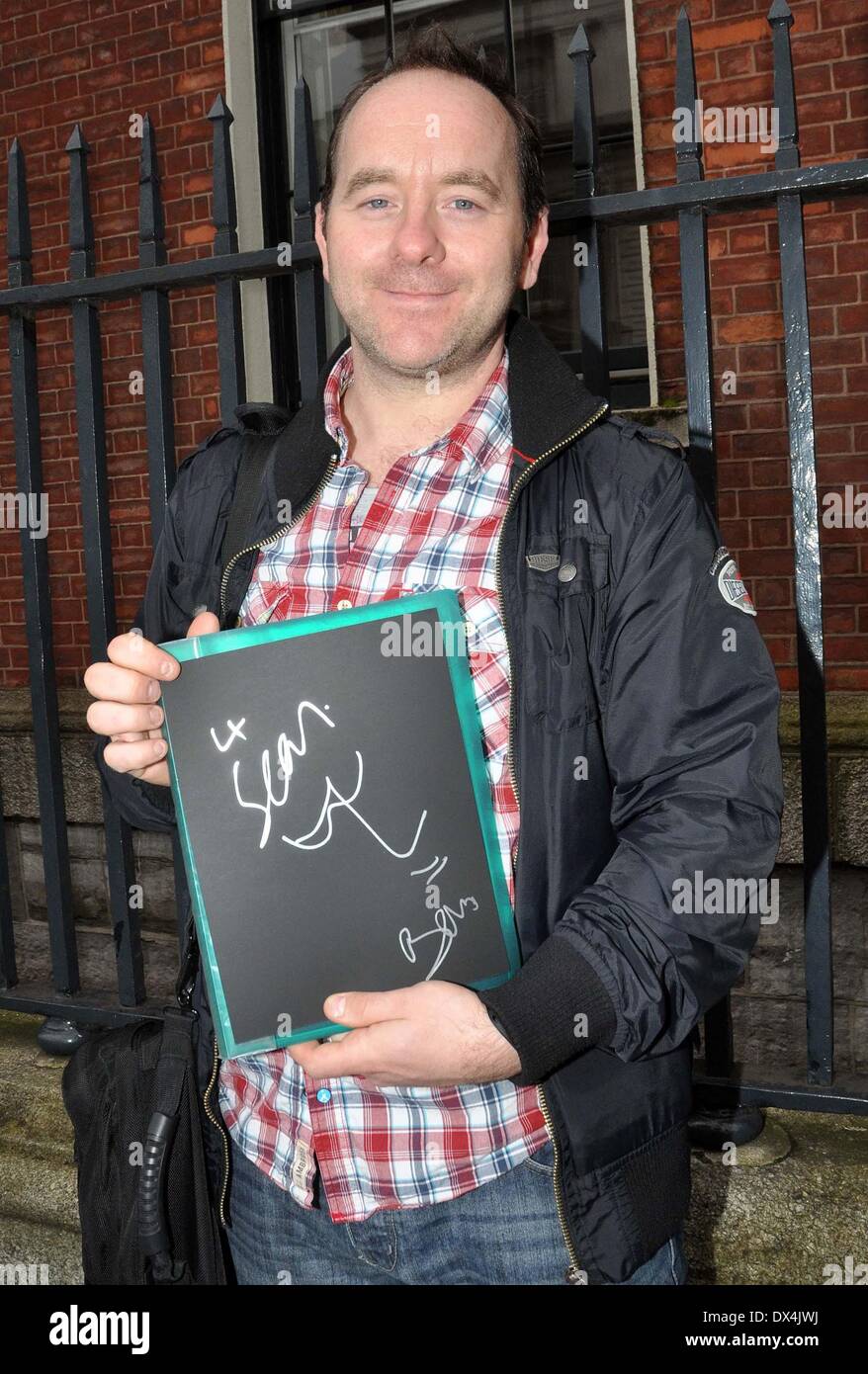 Bono fan Gary Paul shows his signed card after meeting him outside The ...
