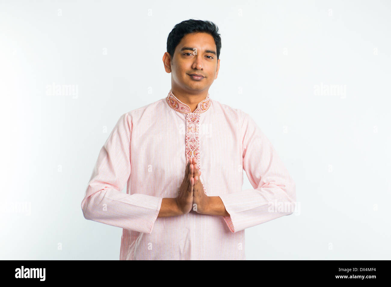 young indian male with Pranamasana greetings sign on traditional dress ...