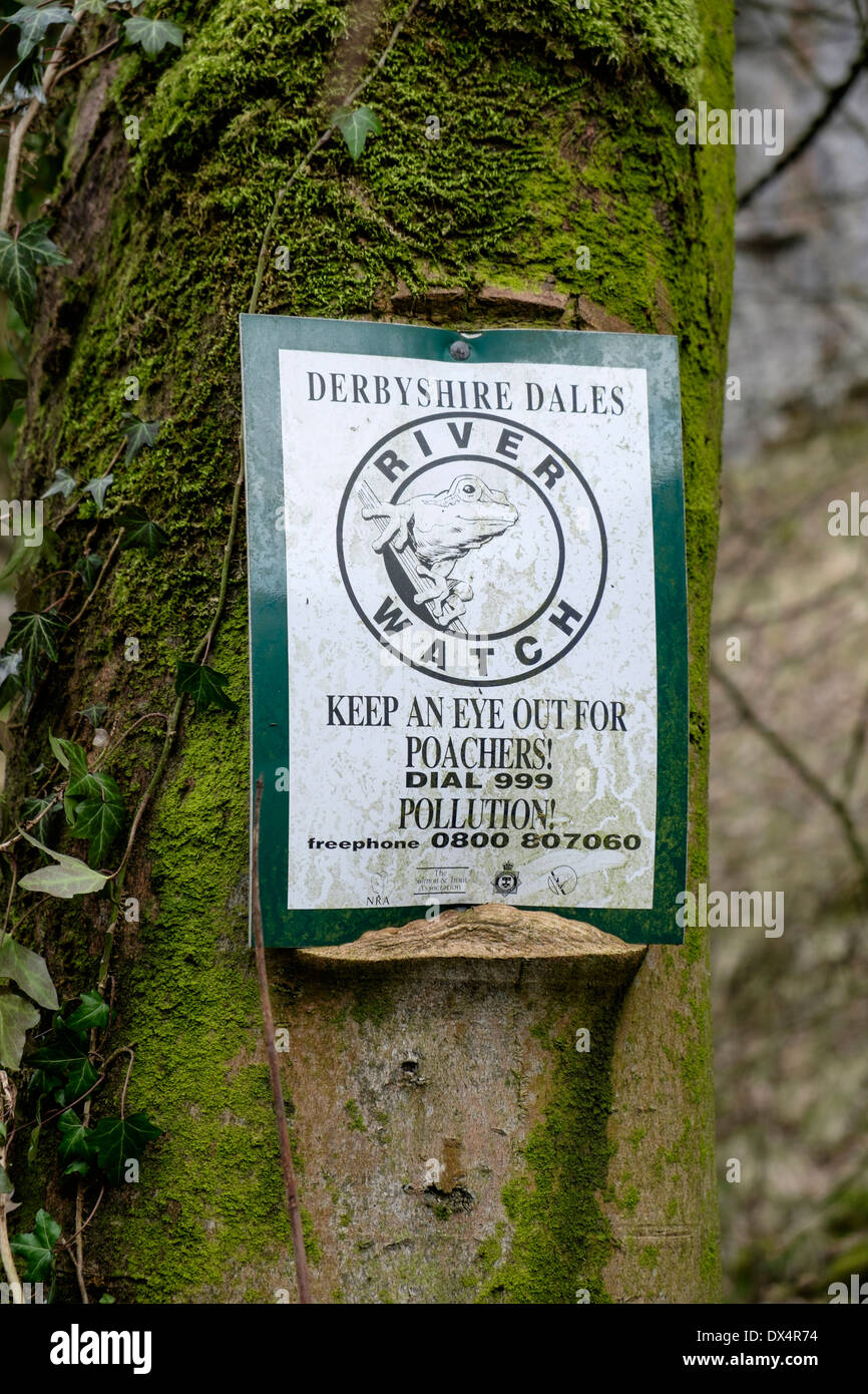 Sign posted on tree warning of poachers on river Derbyshire England ...