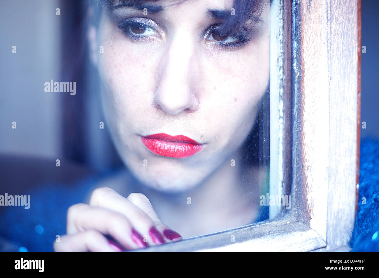 Woman behind a window Stock Photo - Alamy