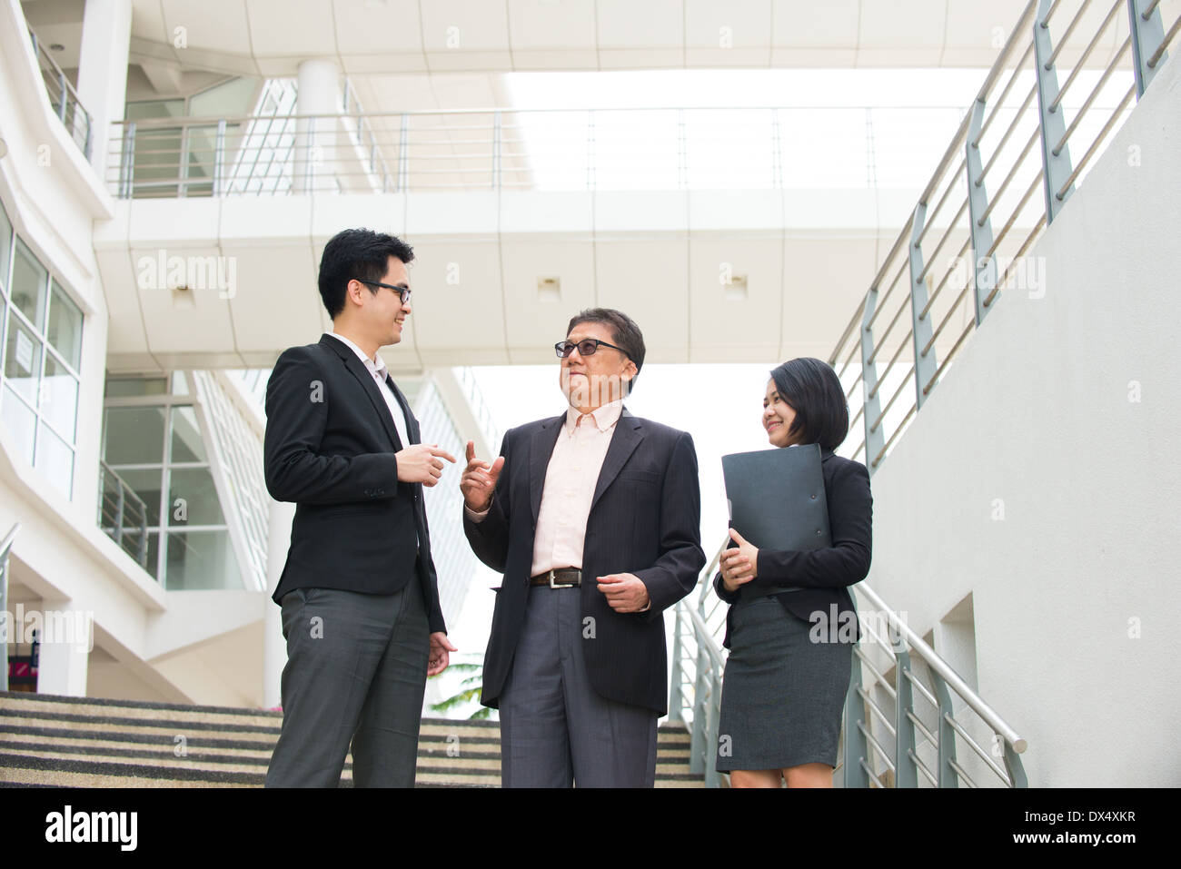 asian business team in conversation with office background Stock Photo ...