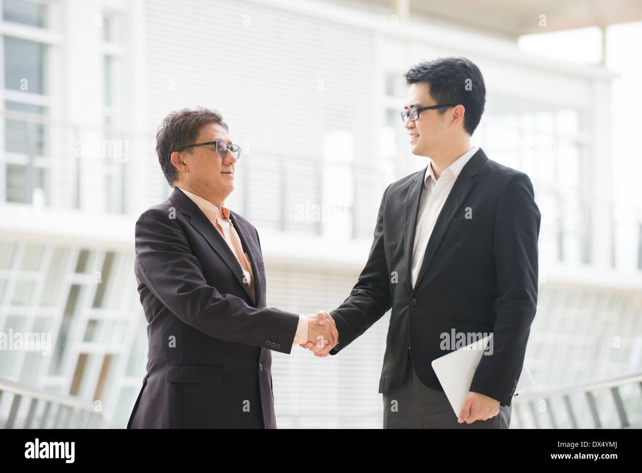 asian business handshake between senior and young business male Stock ...