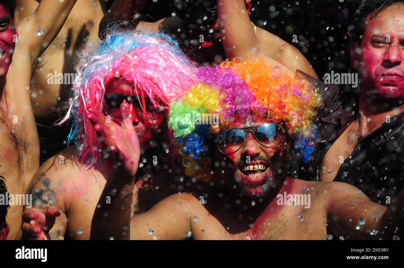 Allahabad, India. 18 March 2014. Indian revellers covered in coloured ...
