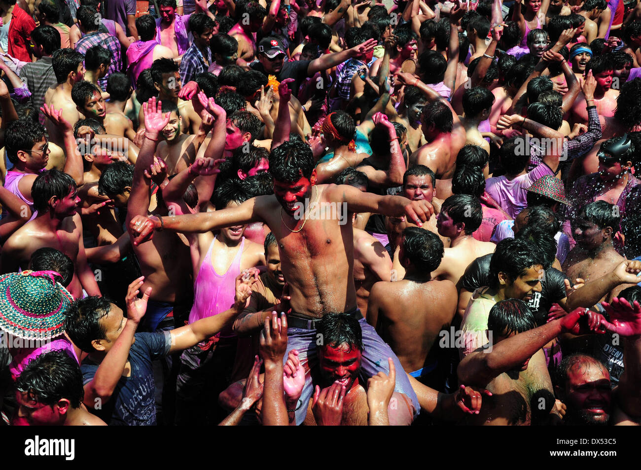 Allahabad, India. 18 March 2014. Indian revellers covered in coloured ...