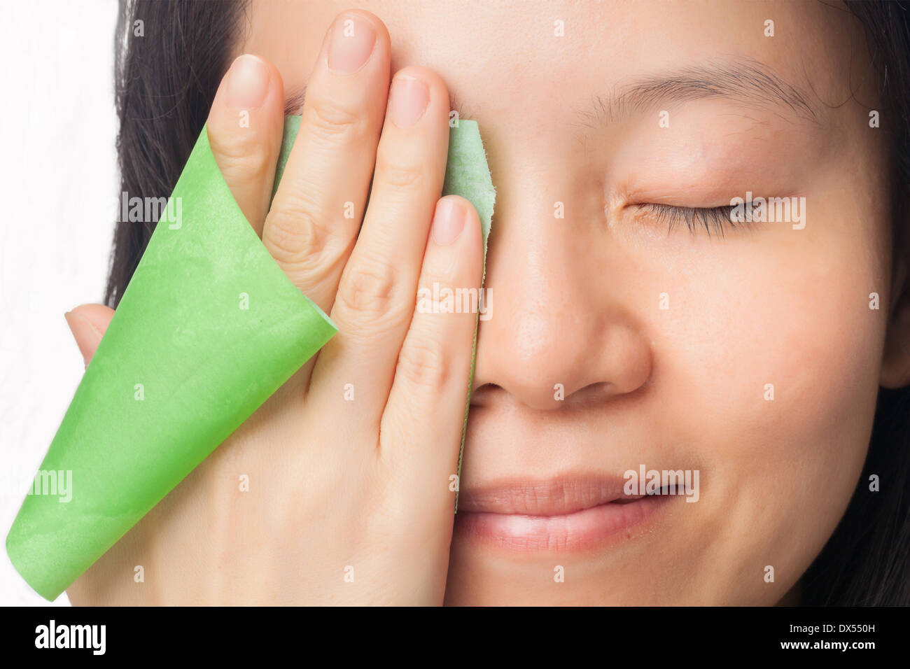 Woman face with oily skin removing oil Stock Photo - Alamy