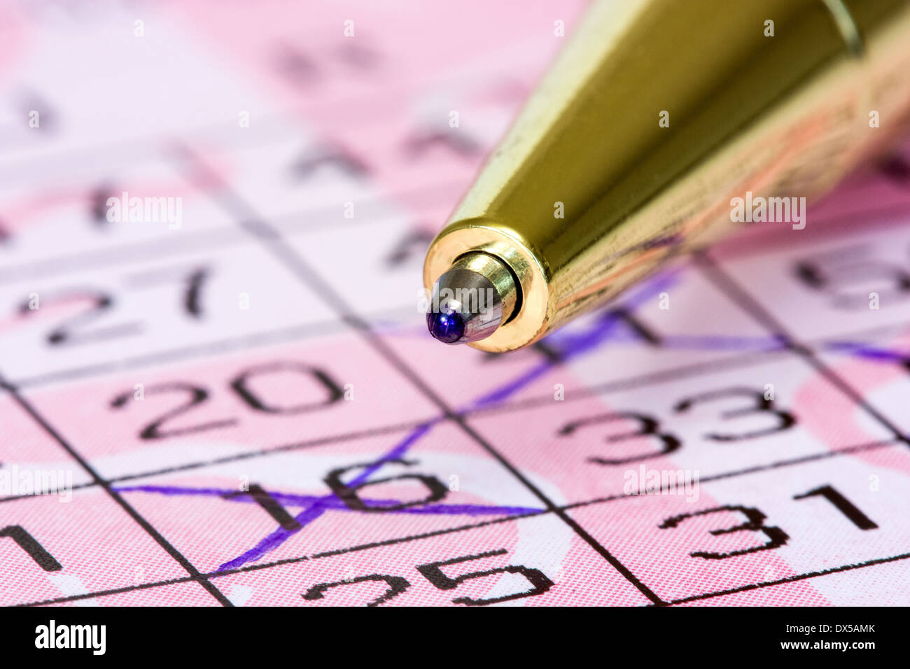 Golden pen and lotto ticket with chosen numbers Stock Photo - Alamy