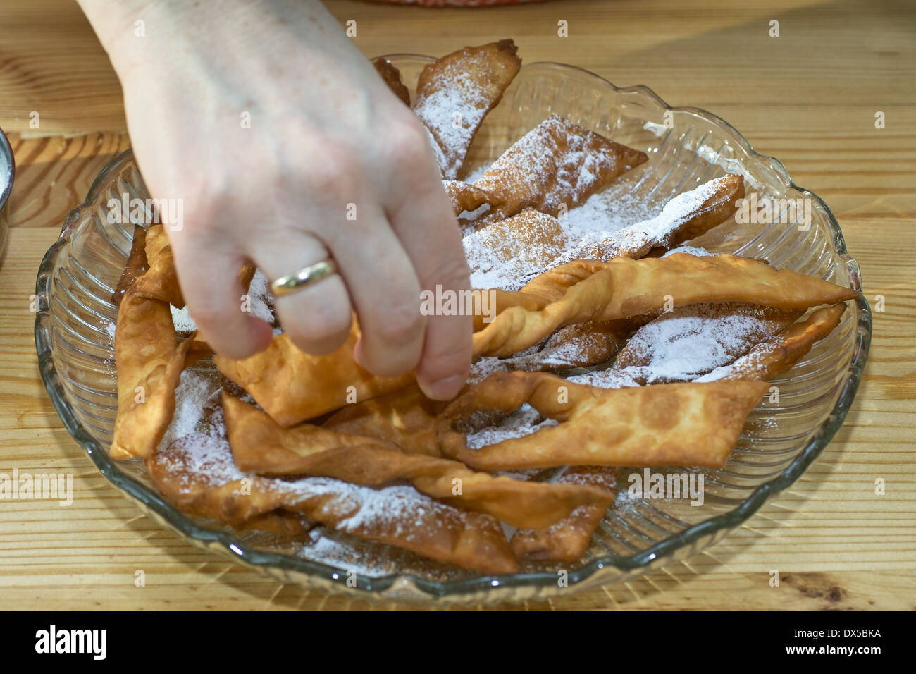 Preparing traditional Polish crunch cakes called Faworki or Chrust ...