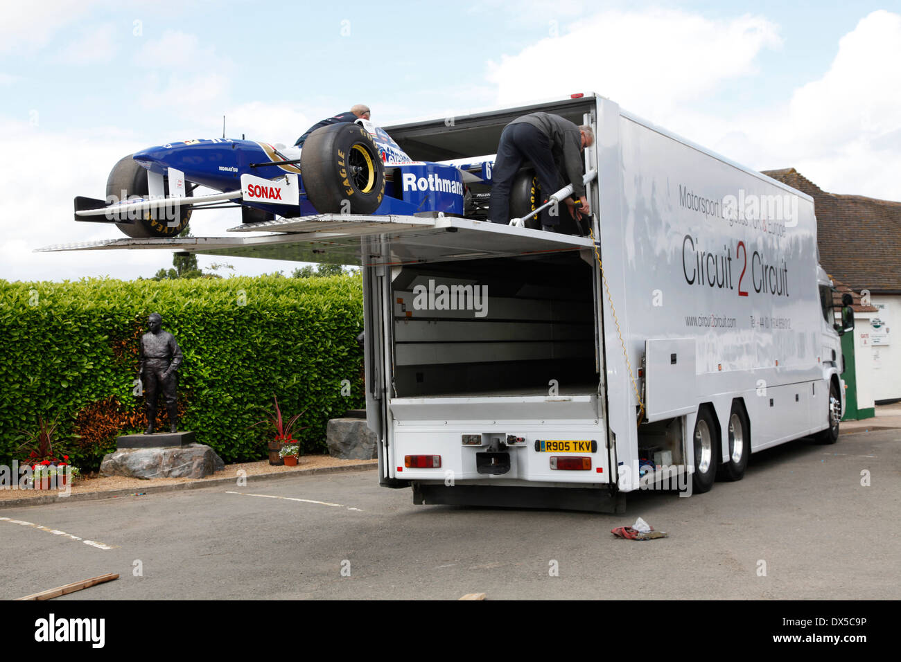 Loading a Williams F1 car designed by Adrian Newey into a car ...