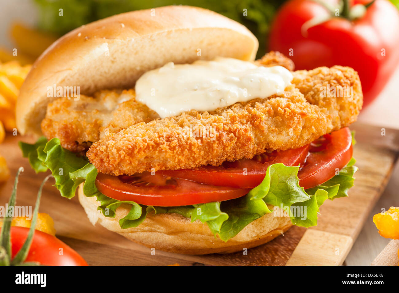 Breaded Fish Sandwich with Tartar Sauce and Fries Stock Photo - Alamy