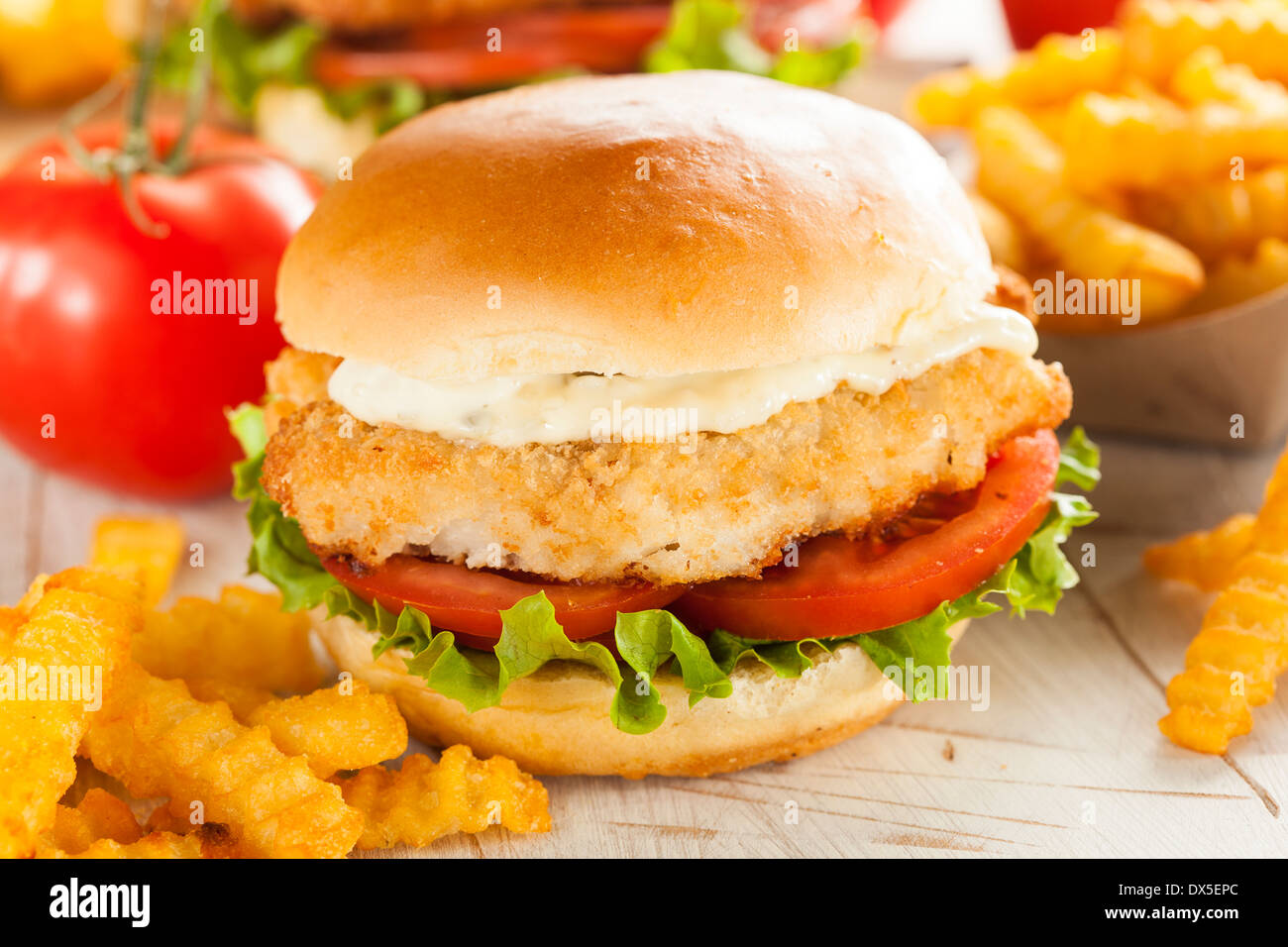 Breaded Fish Sandwich with Tartar Sauce and Fries Stock Photo - Alamy