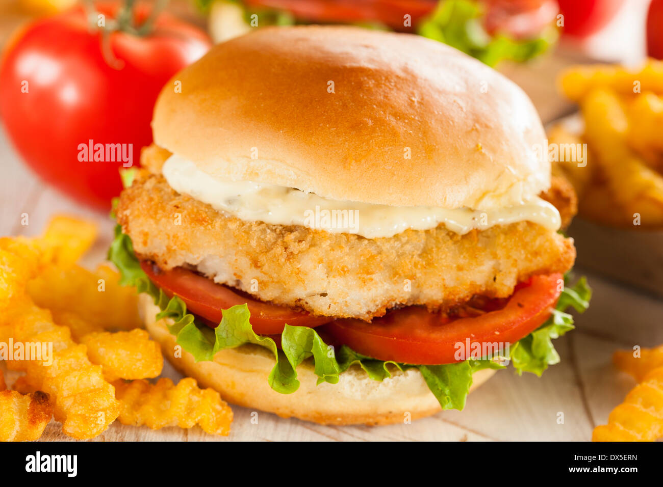Breaded Fish Sandwich with Tartar Sauce and Fries Stock Photo - Alamy