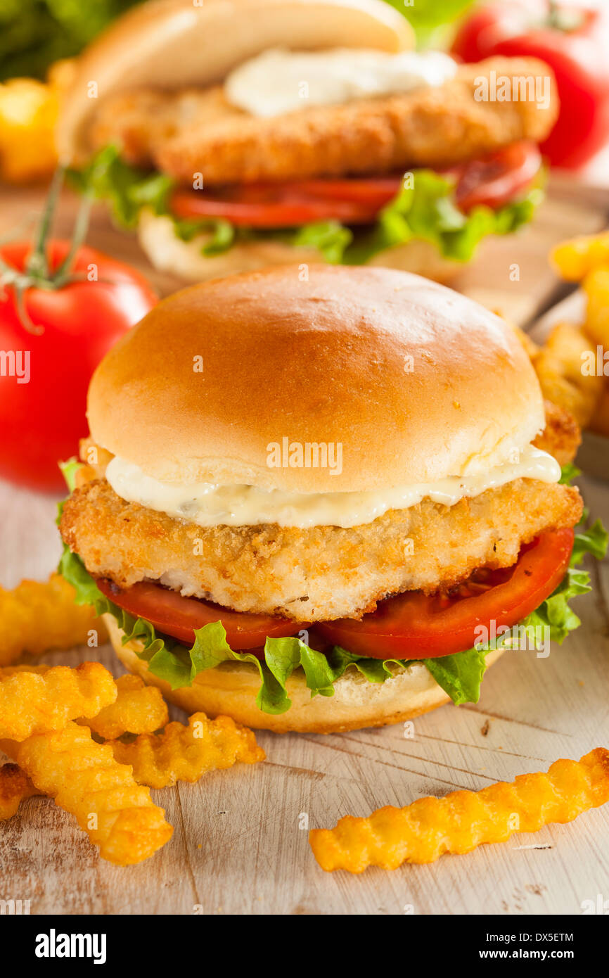 Breaded Fish Sandwich with Tartar Sauce and Fries Stock Photo - Alamy