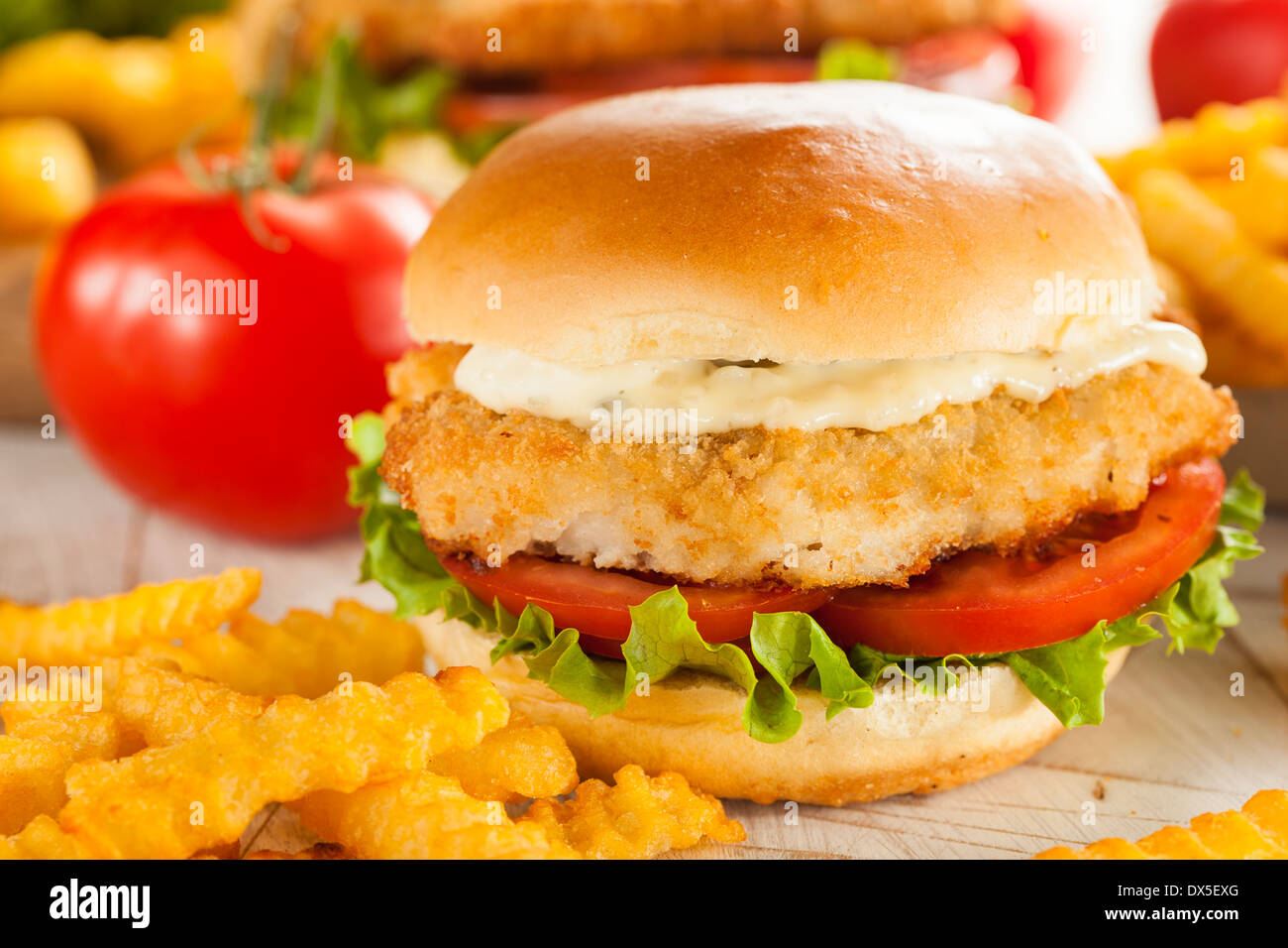 Breaded Fish Sandwich with Tartar Sauce and Fries Stock Photo - Alamy