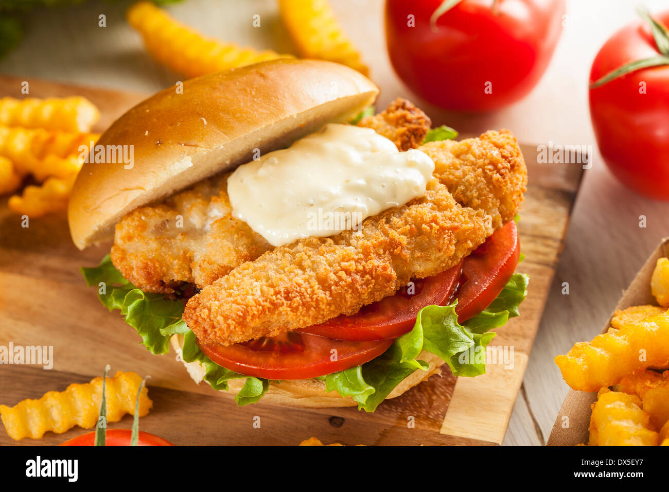 Breaded Fish Sandwich with Tartar Sauce and Fries Stock Photo - Alamy