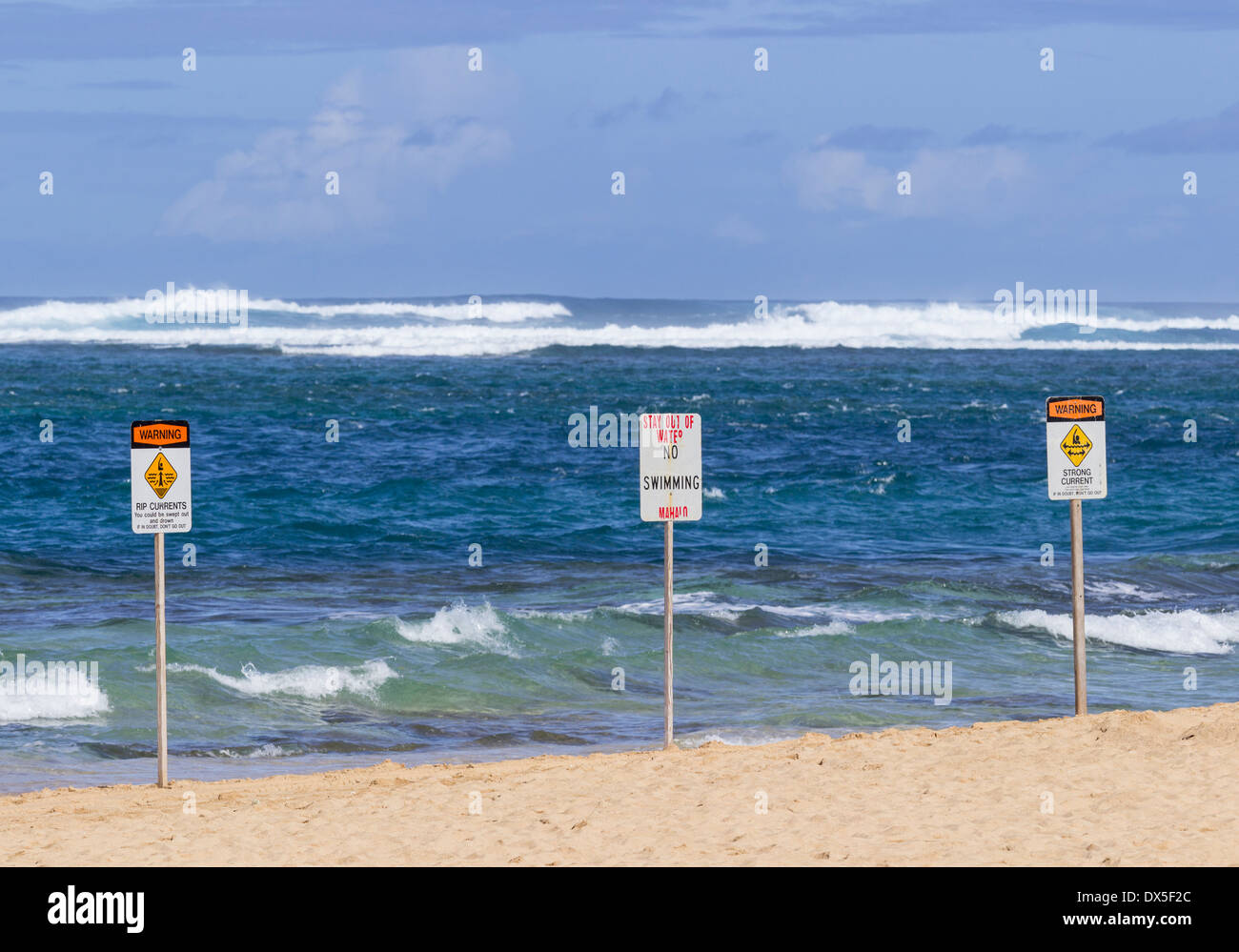 Three warning signs on a beach in Hawaii - no swimming and strong ...