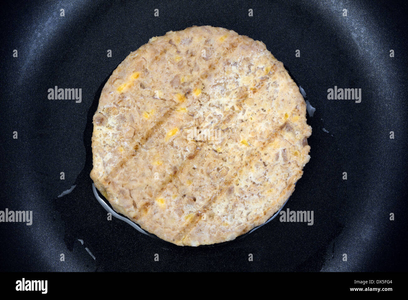 Close view of a single vegetable burger patty cooking in skillet Stock ...