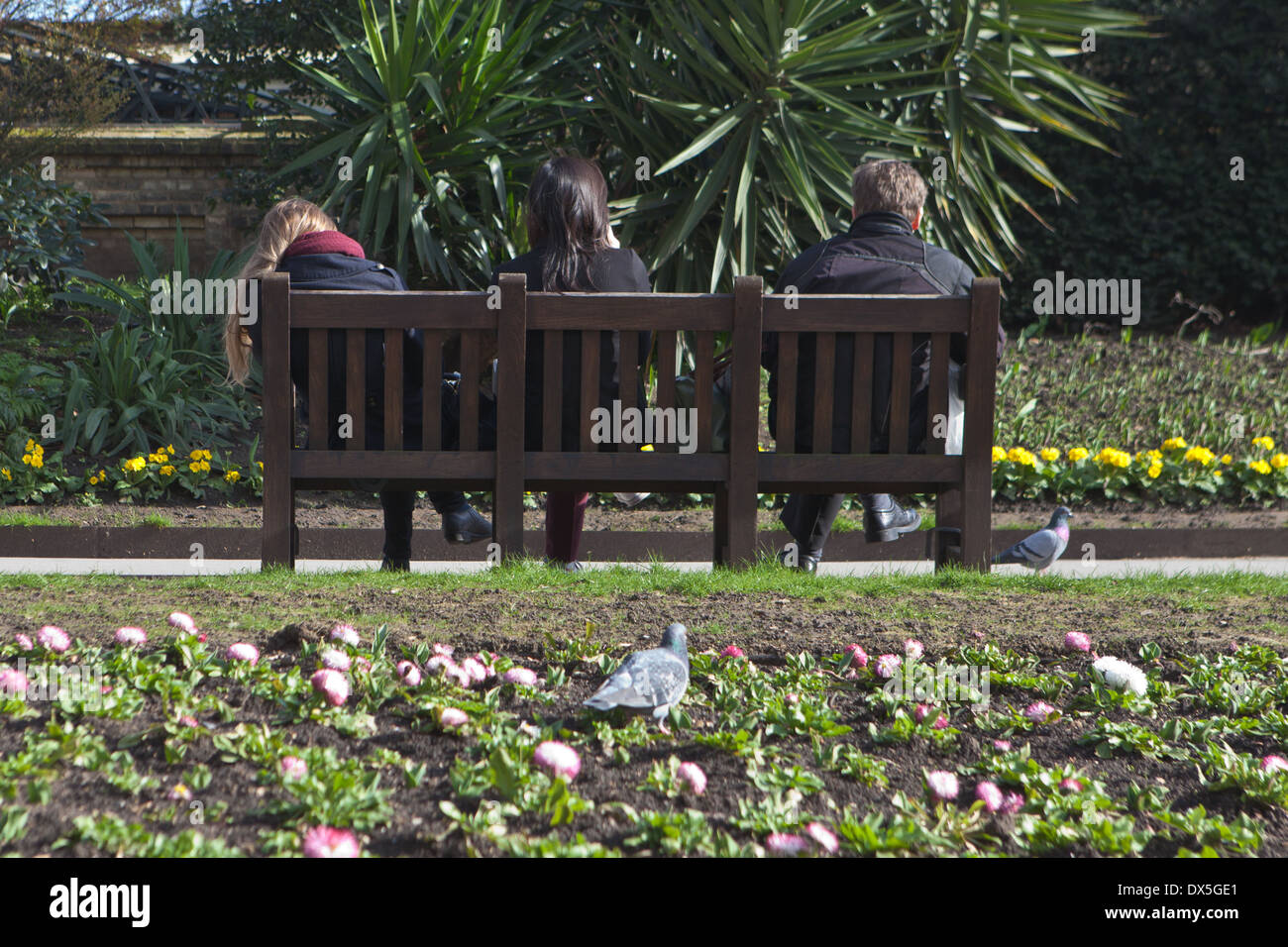 Three people sitting bench hi-res stock photography and images - Alamy