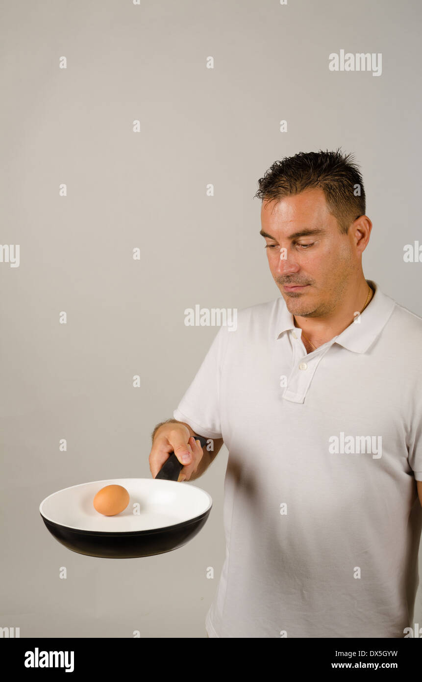 A clueless guy showing us how not to cook an egg Stock Photo - Alamy