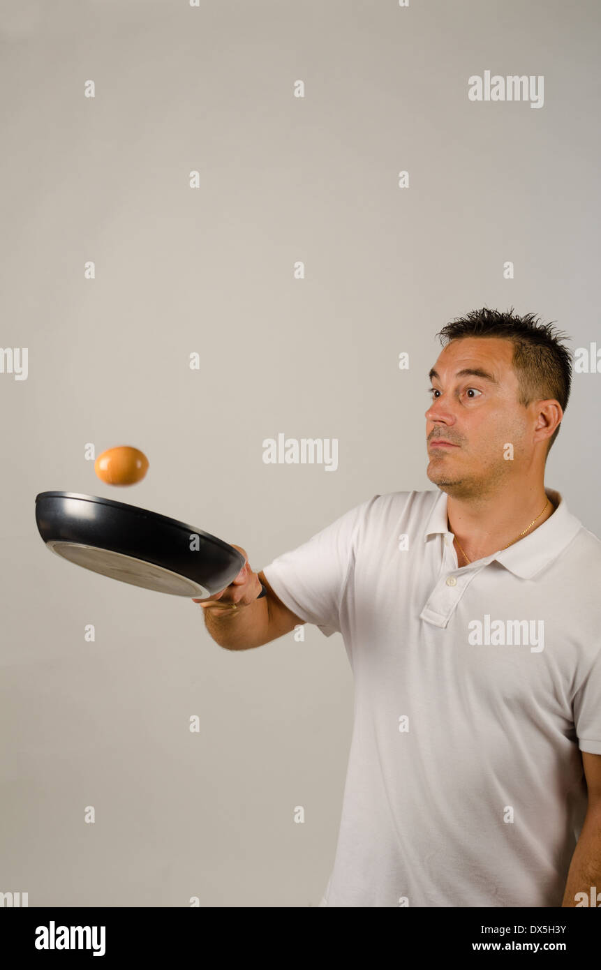 A clueless guy showing us how not to cook an egg Stock Photo - Alamy