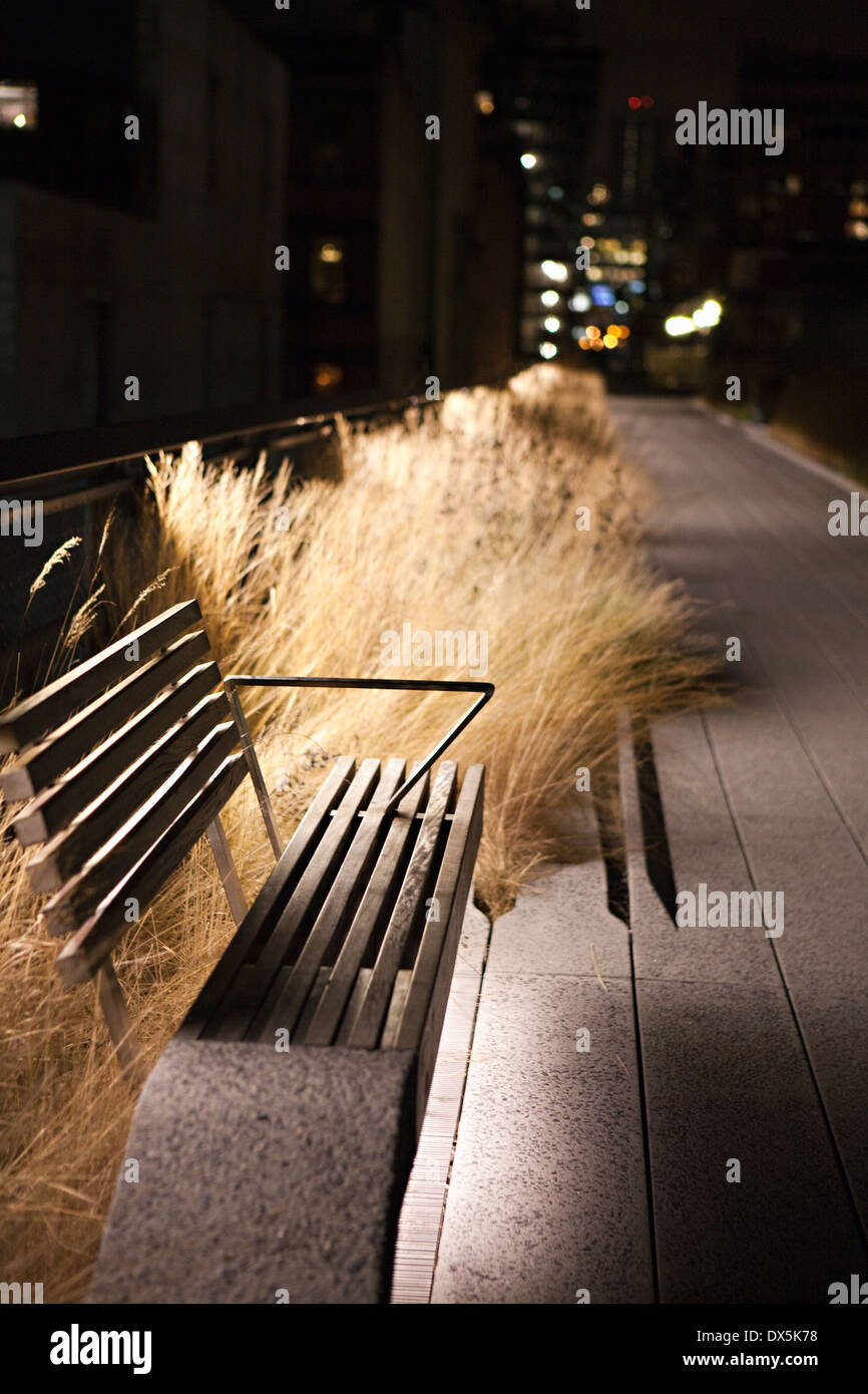 Illuminated park bench and meadow grass in High Line Park at night, New ...