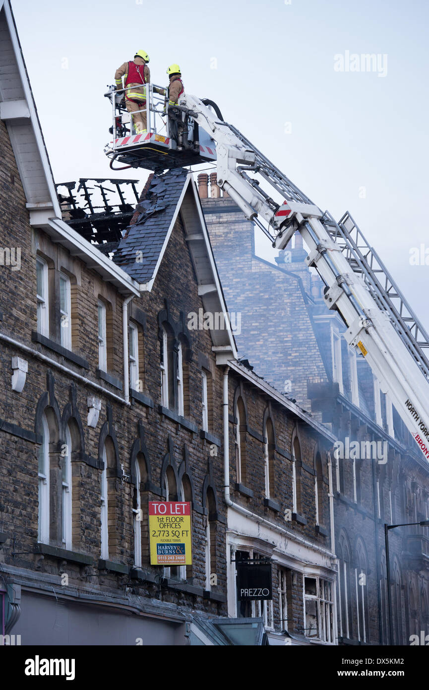 Brave firefighter crew (2 firefighters) up high ladder on platform ...