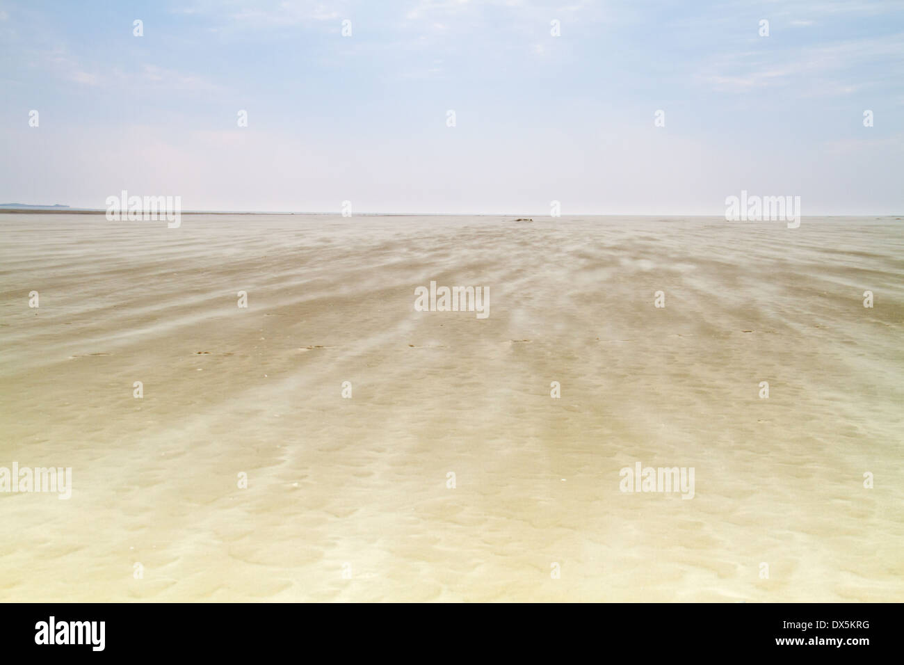 Moving sand on a windy beach Stock Photo - Alamy