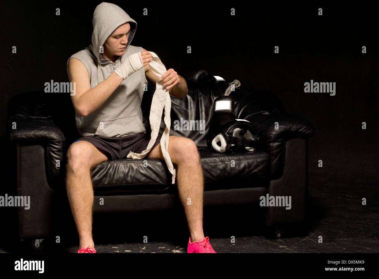 Muscular boxer bandaging his hands Stock Photo - Alamy