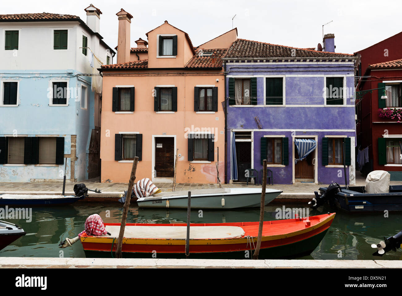 Burano an island known for brightly multi colored homes and boats on ...