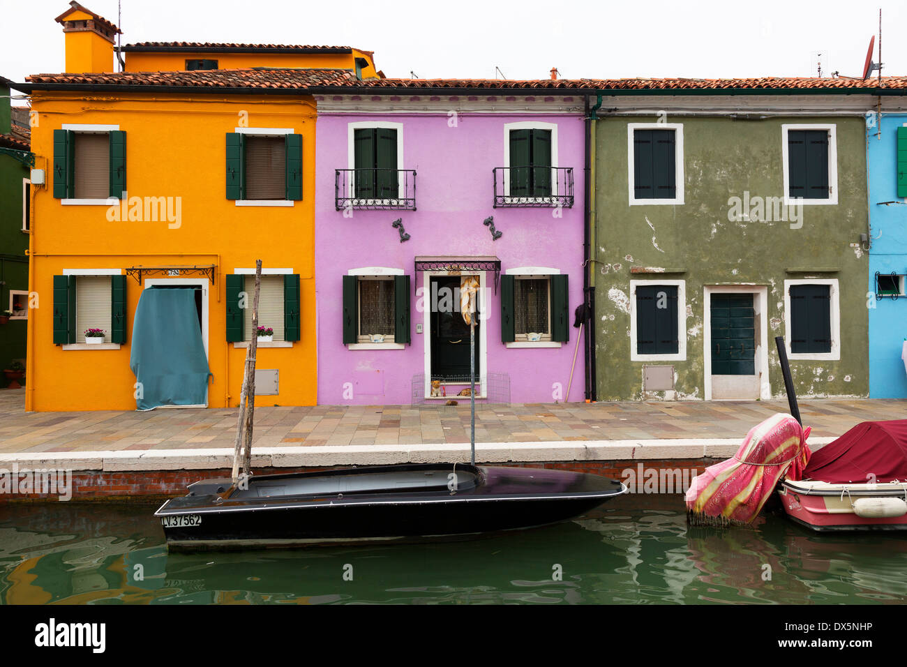 Burano an island known for brightly multi colored homes and boats on ...