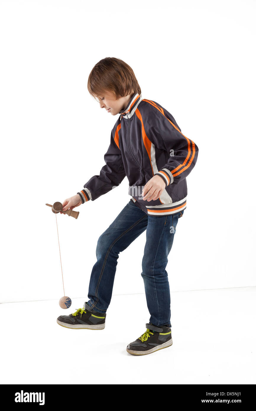 young boy playing kendama isolated Stock Photo - Alamy
