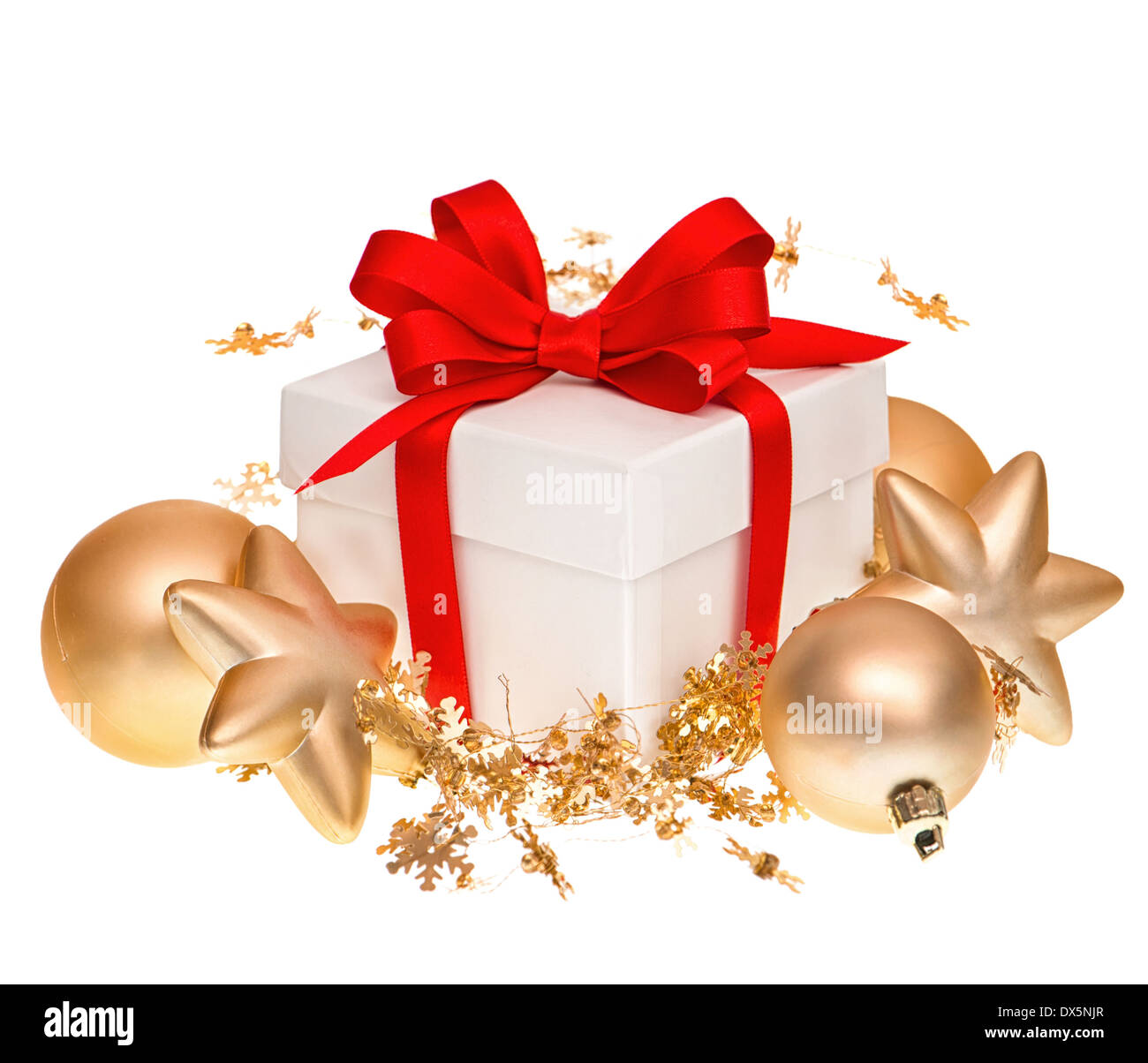 white gift box with red ribbon and golden balls decoration on white ...