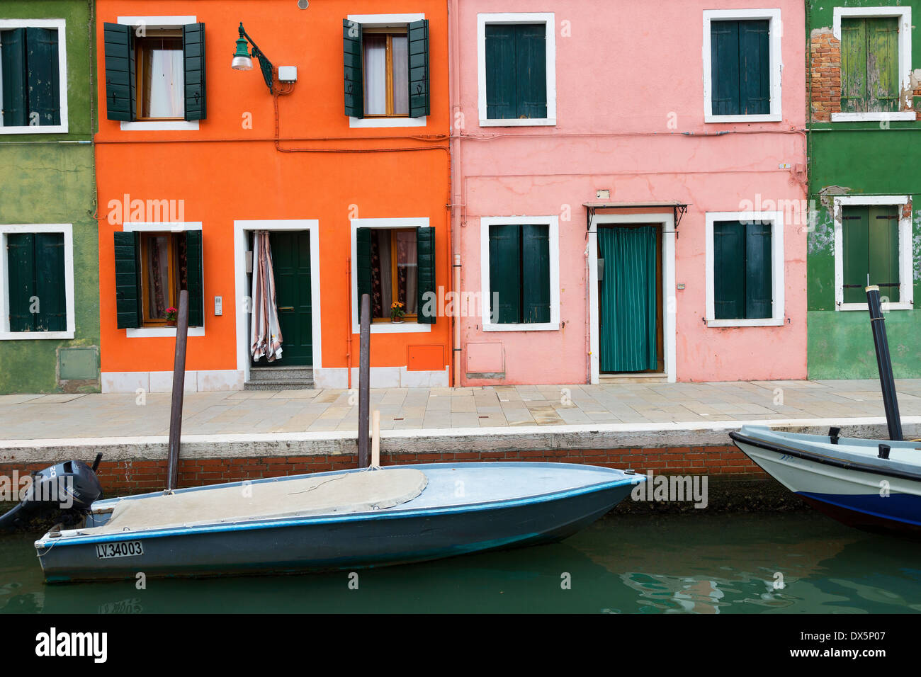 Burano an island known for brightly multi colored homes and boats on ...