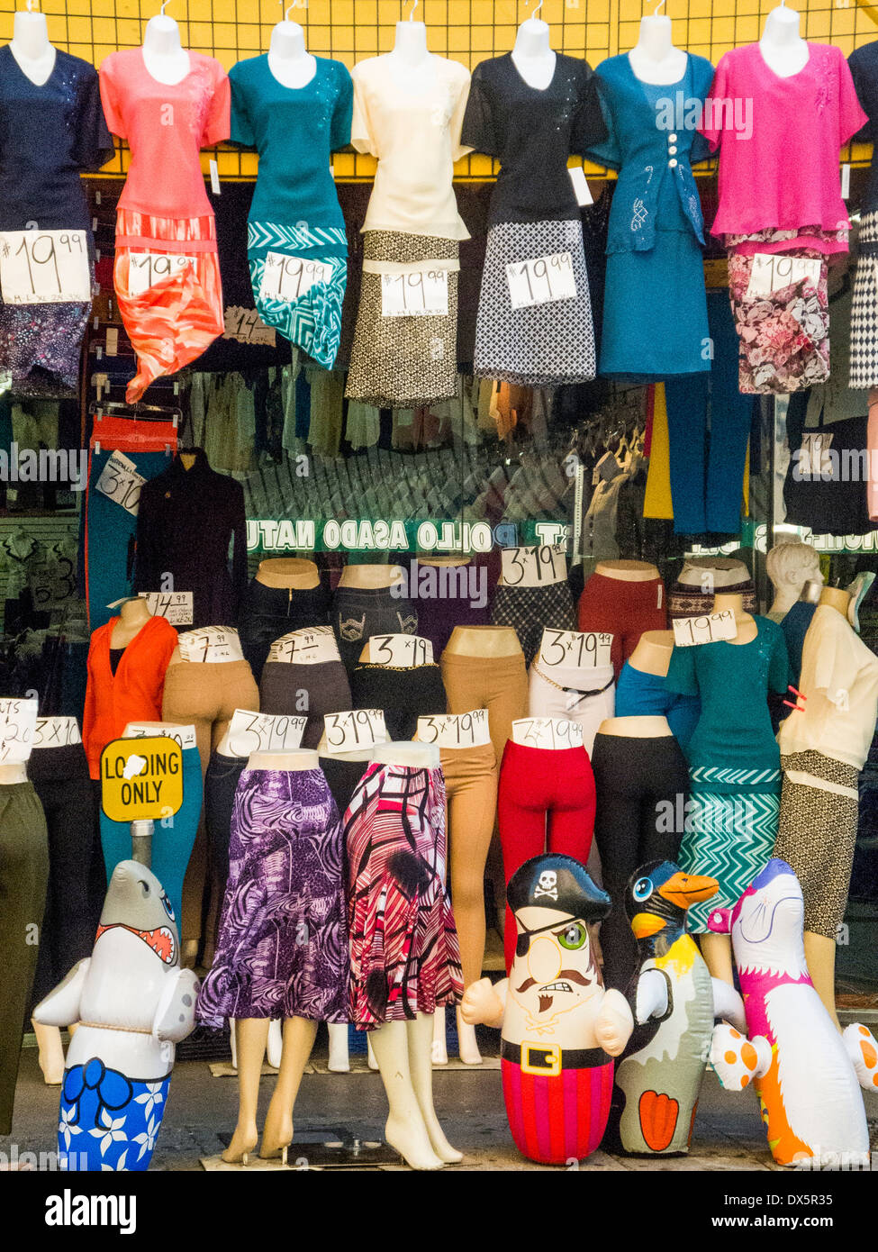 Displayed on partial body mannequins, a sidewalk clothing sale in the ...
