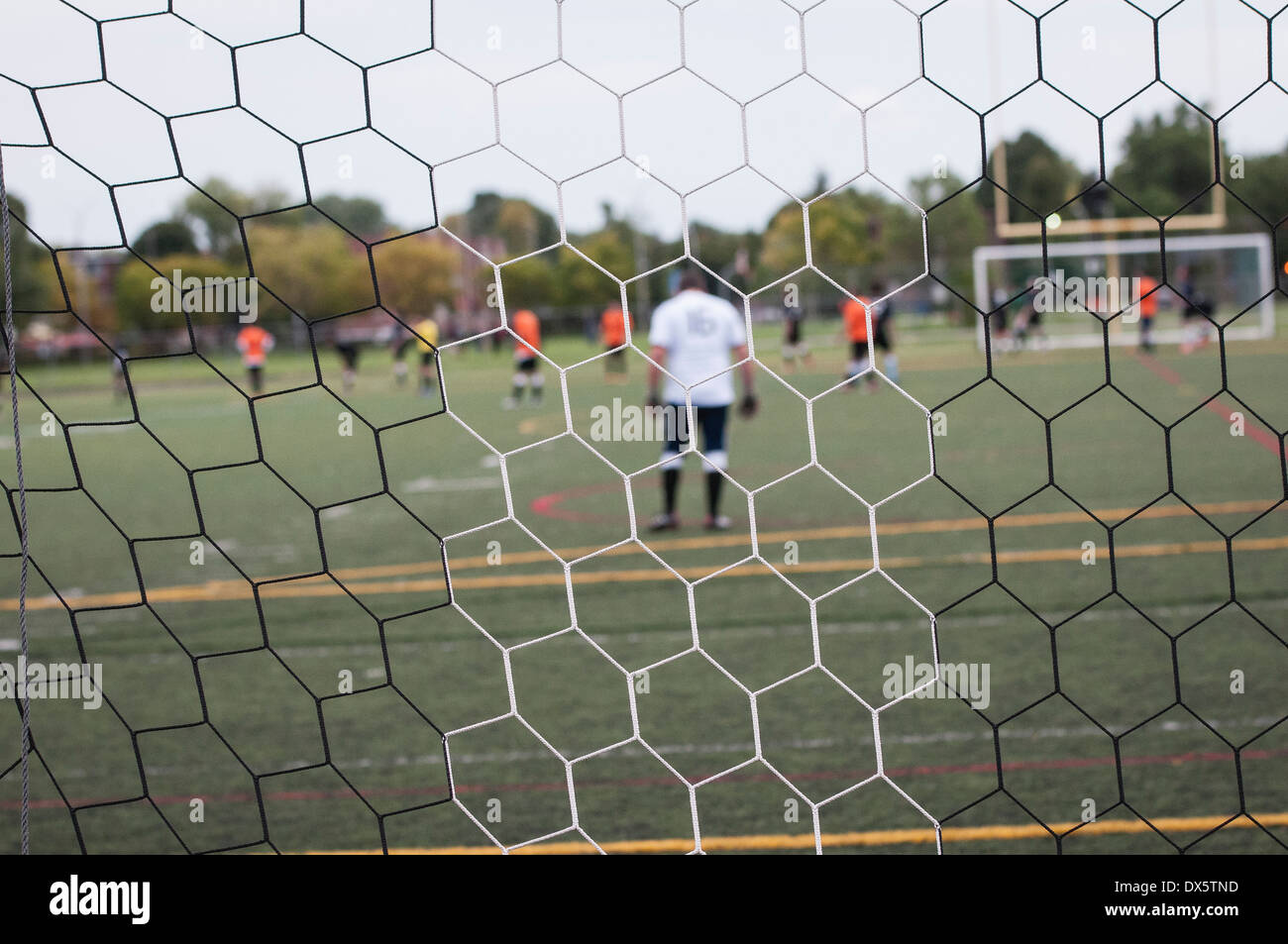 Soccer game through the goal net Stock Photo - Alamy