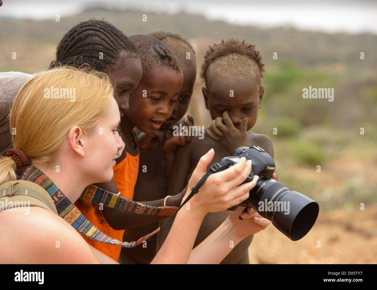 Hamer children and tourist enjoying a photograph near Turmi in the Omo ...