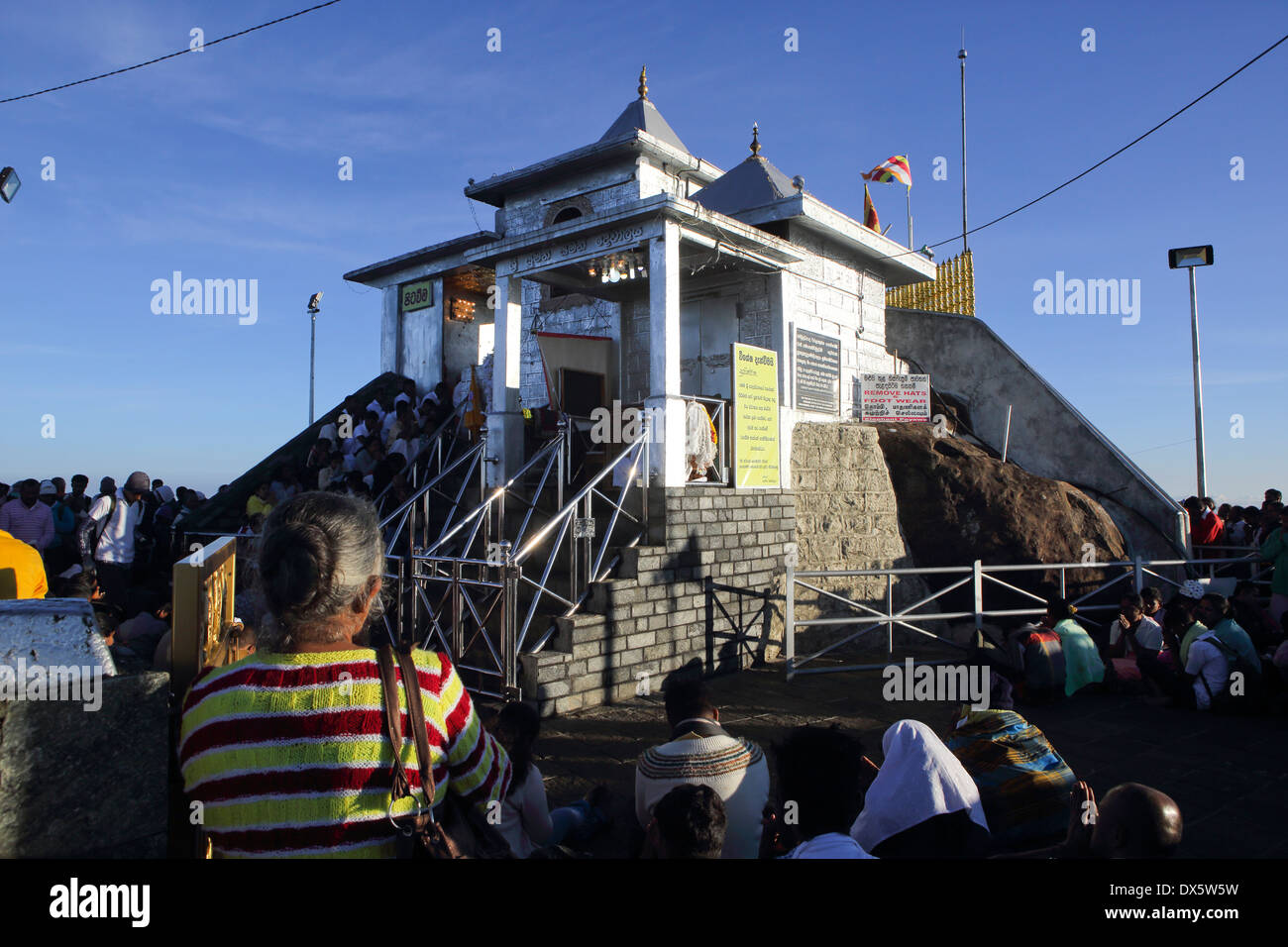 Buddhist pilgrims prey at dawn at the temple at the summit of Adam's ...