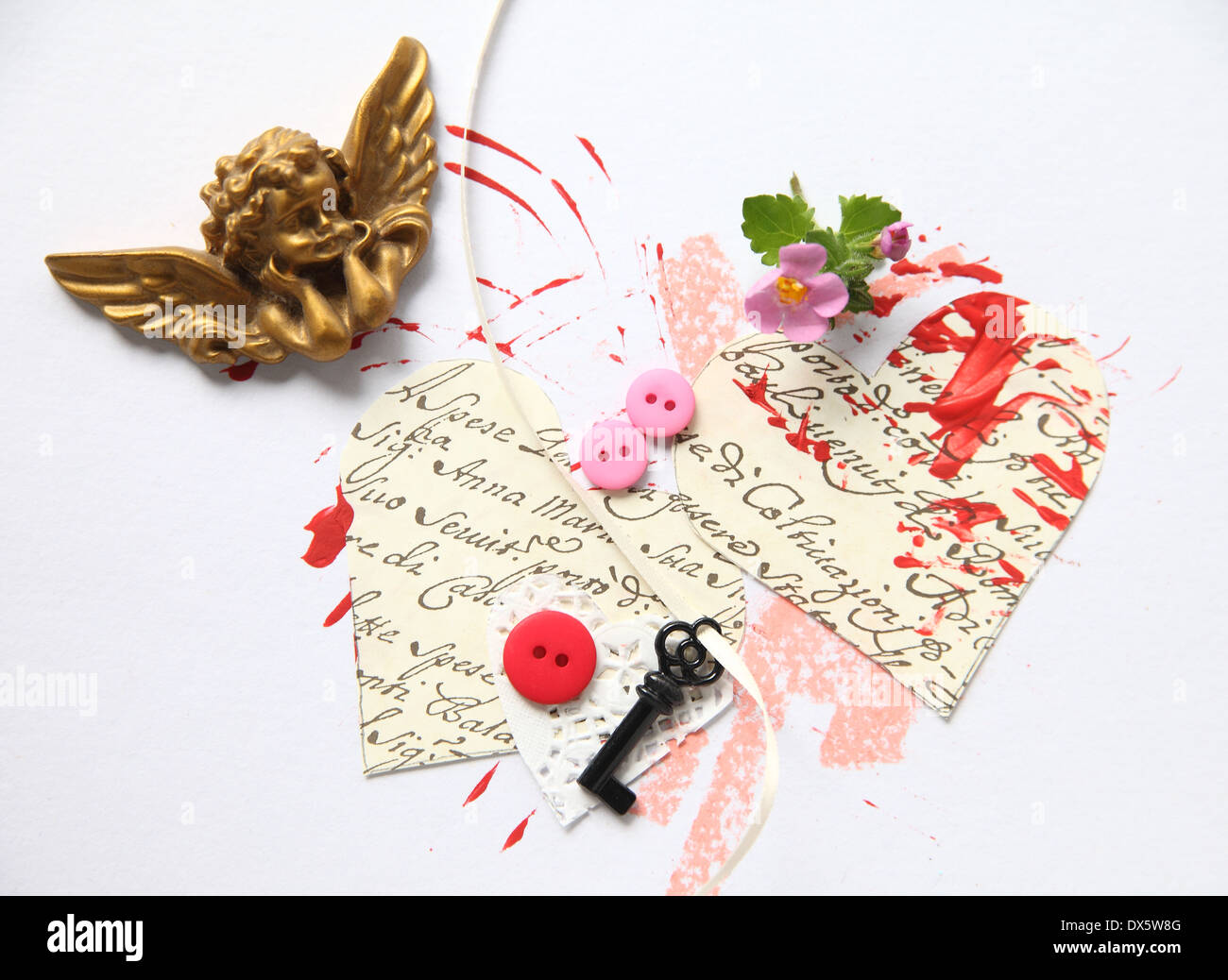 collage with an angel, hearts with old script, buttons, a key and paint ...