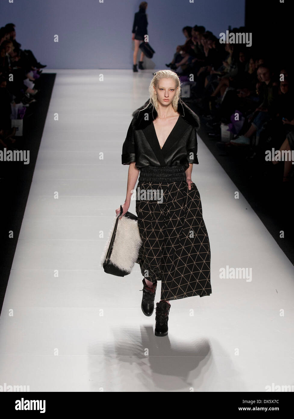 Toronto, Canada. 18th Mar, 2014. A model walks the runway wearing ...