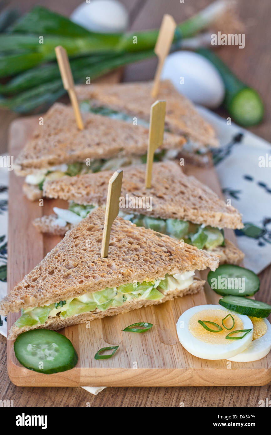 Traditional five-o-clock sandwiches with egg, cucumber and spring onion ...