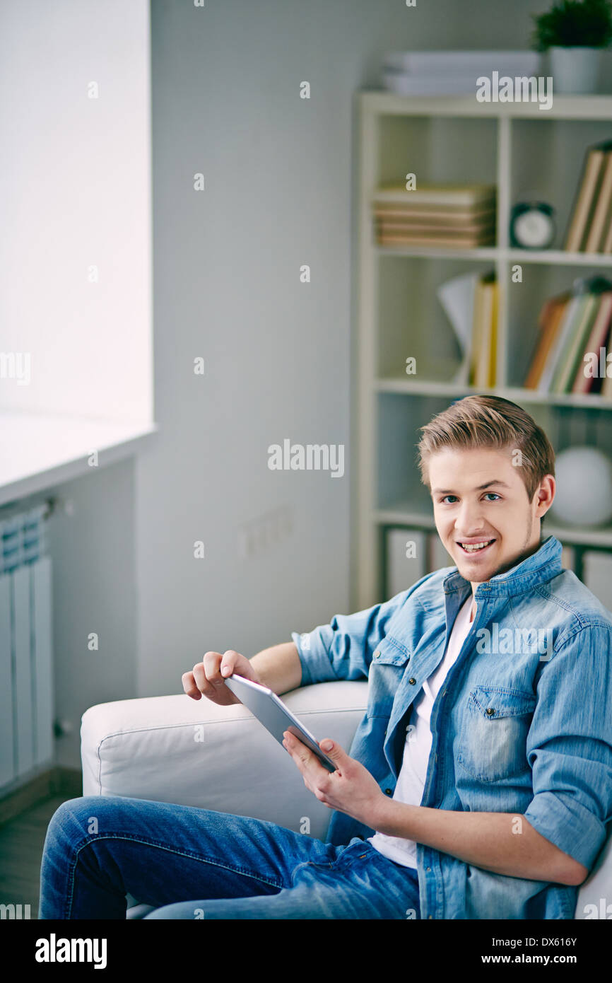 A young guy with touchpad looking at camera Stock Photo - Alamy