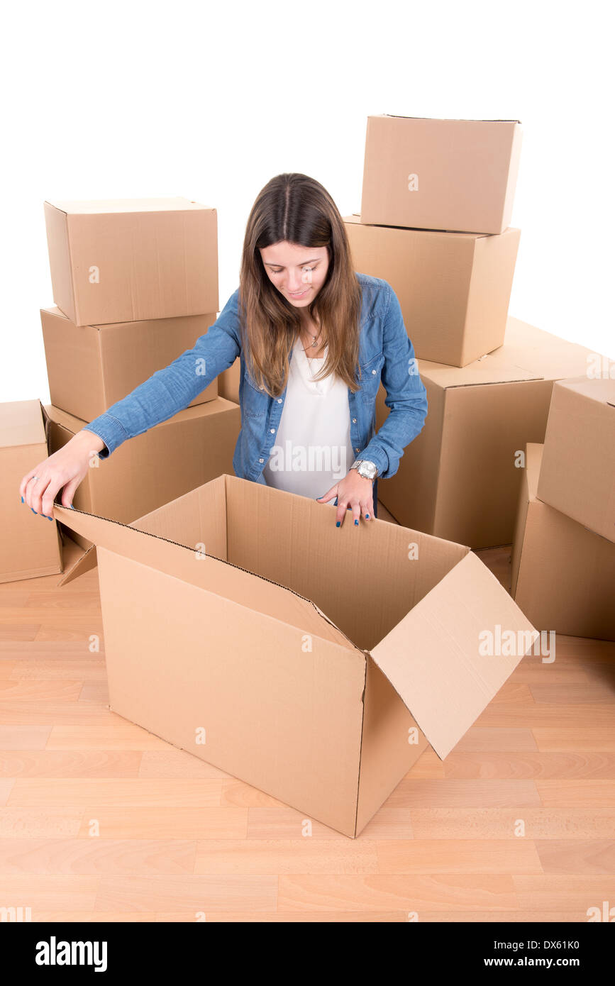Beautiful girl with cardboard boxes unpacking in new home Stock Photo ...
