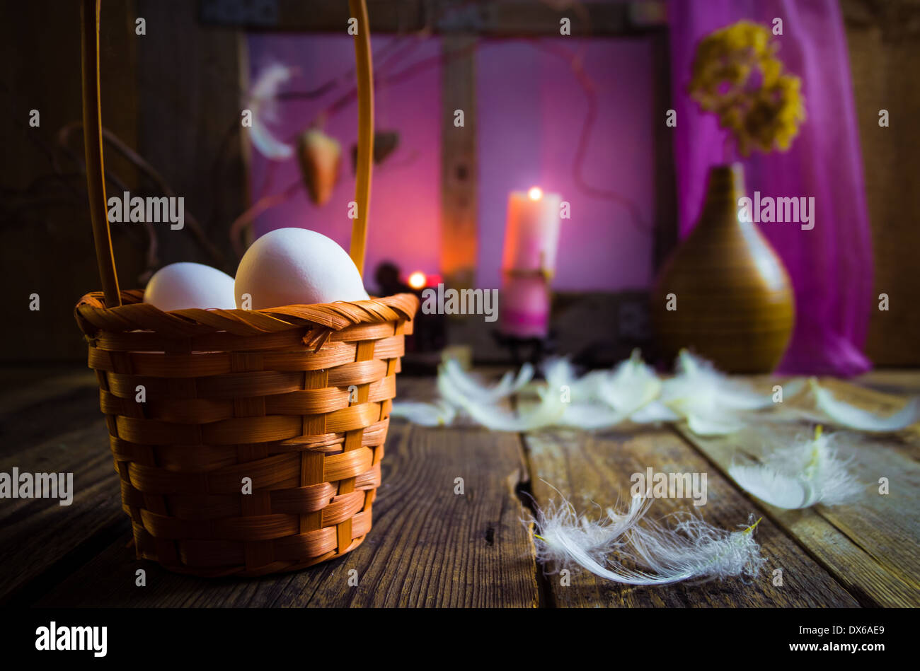 Vintage Easter basket with eggs and feathers Stock Photo - Alamy