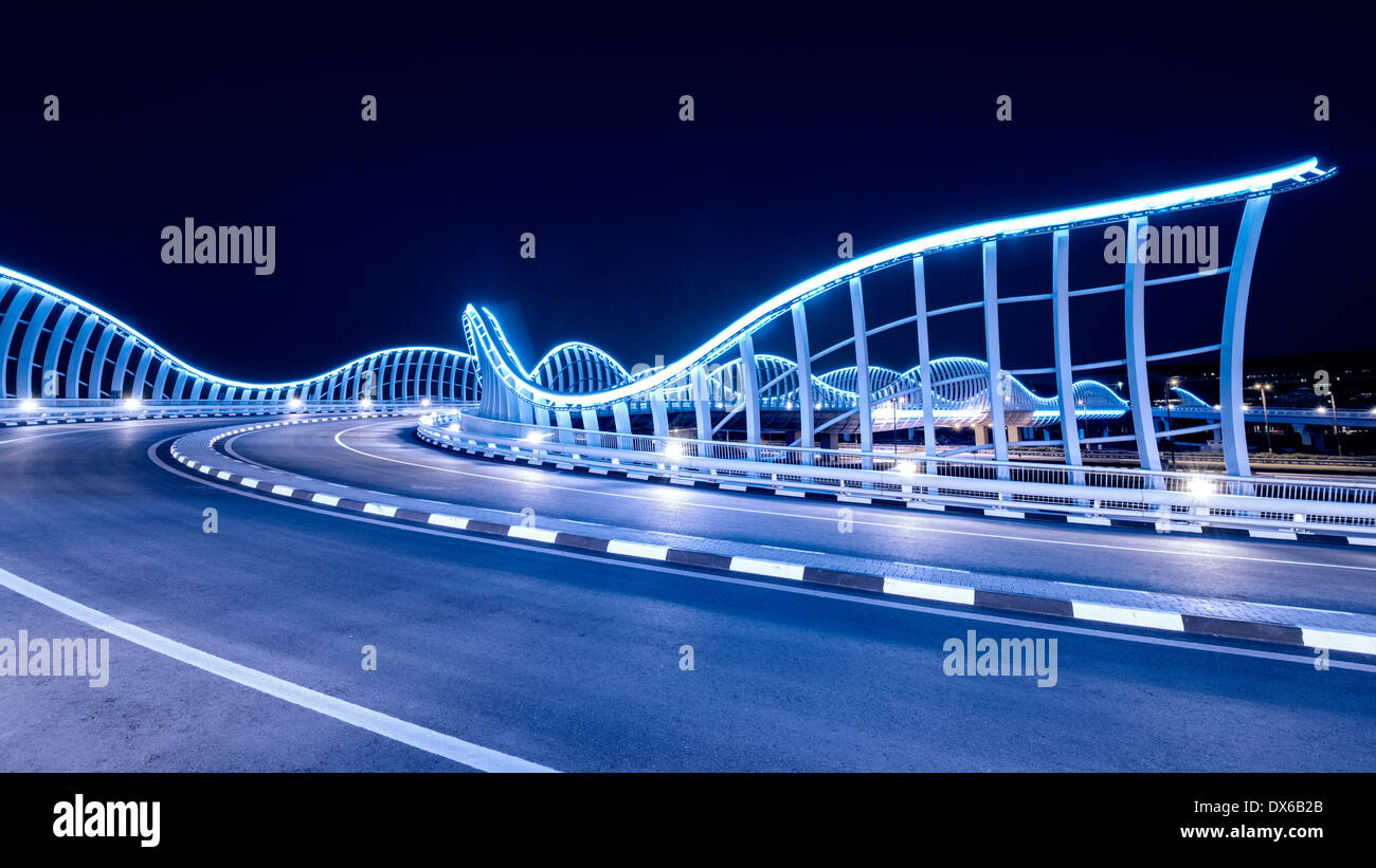 Modern architectural illuminated bridge at Meydan racecourse in Dubai ...
