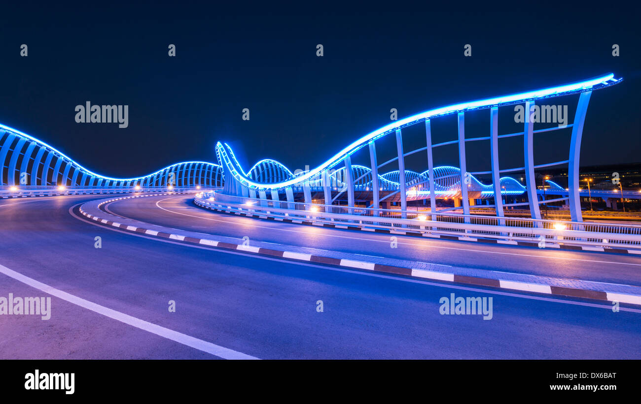 Modern architectural illuminated bridge at Meydan racecourse in Dubai ...