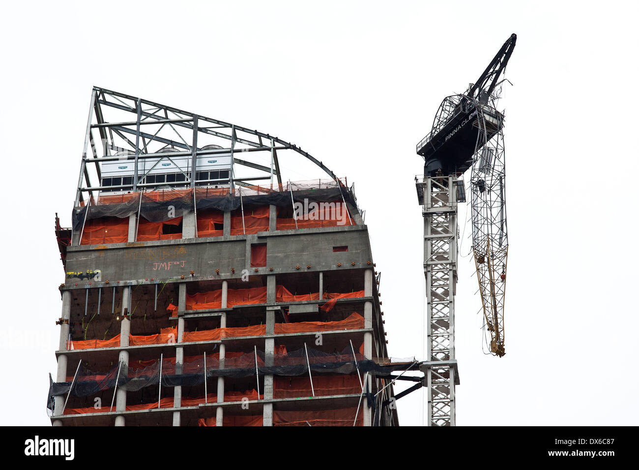 A crane boom that was damaged by Hurricane Sandy is still dangling from ...