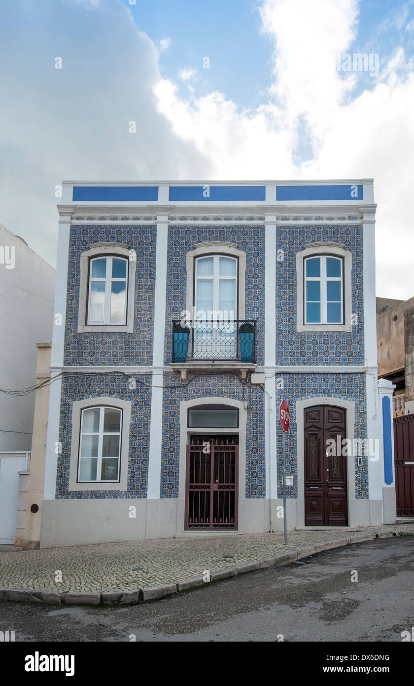 Traditional tiled building and mosaic tiled street in the old town of ...